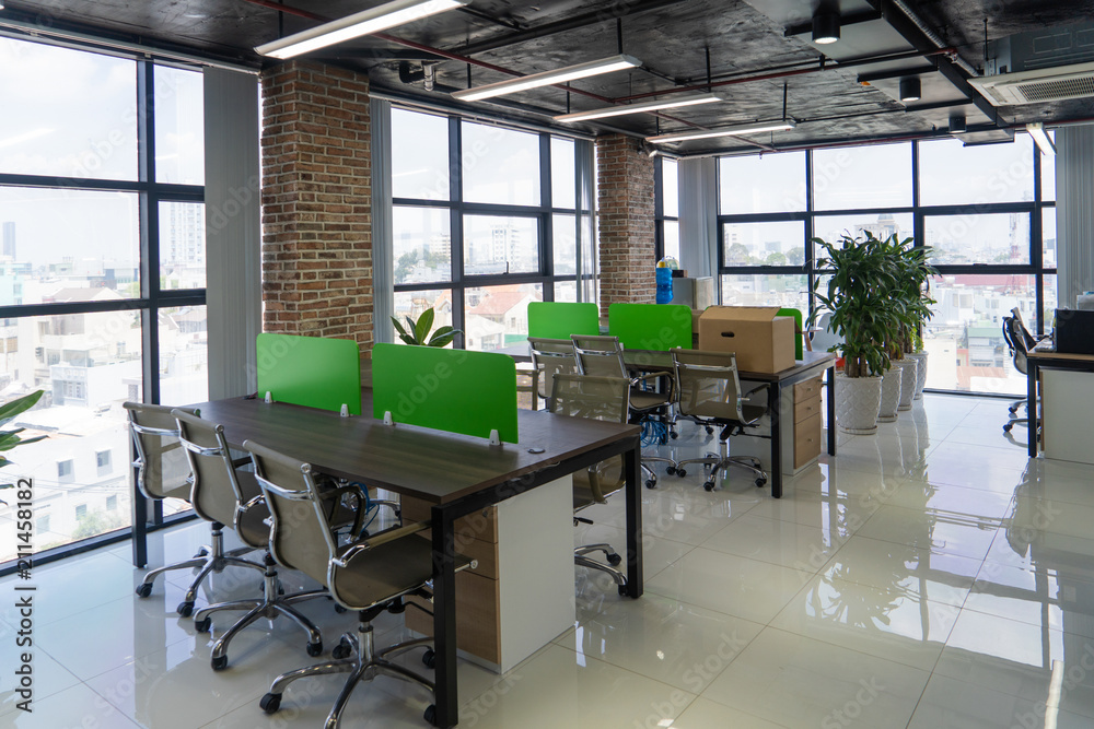 Empty room with tables in modern office. Open space in loft style ...