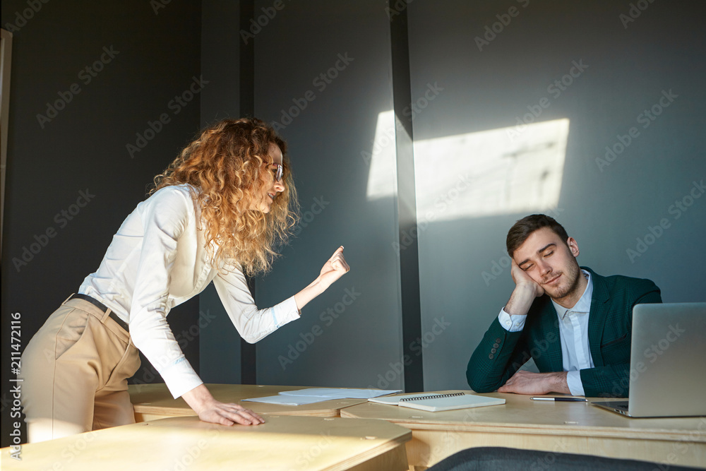 Picture of angry young female boss with long wavy hair making warning ...