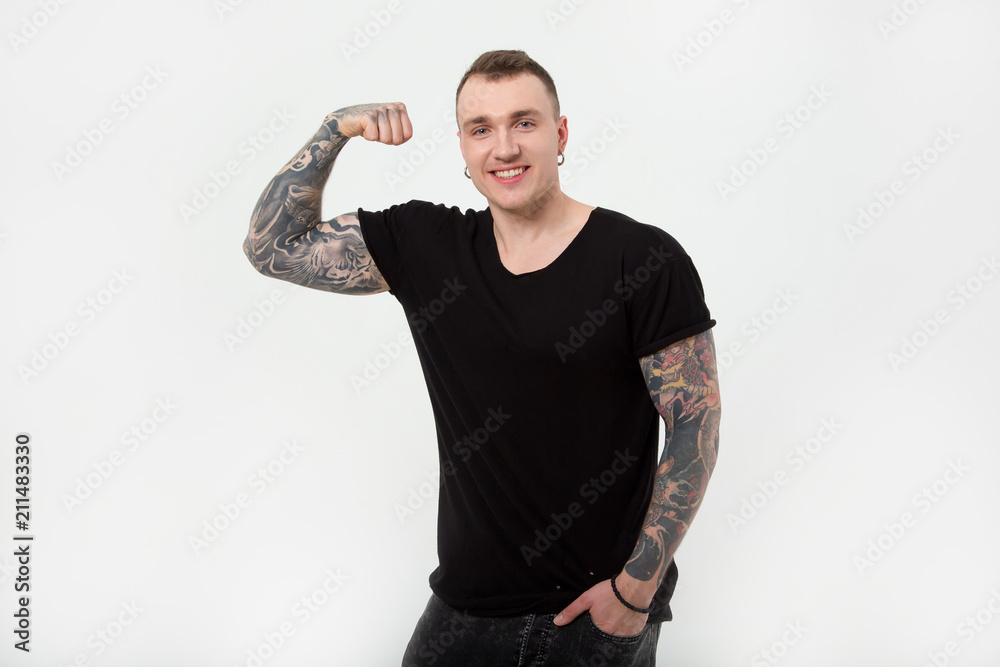 Young strong man with tattoos on his hands. Modern male, subculture ...