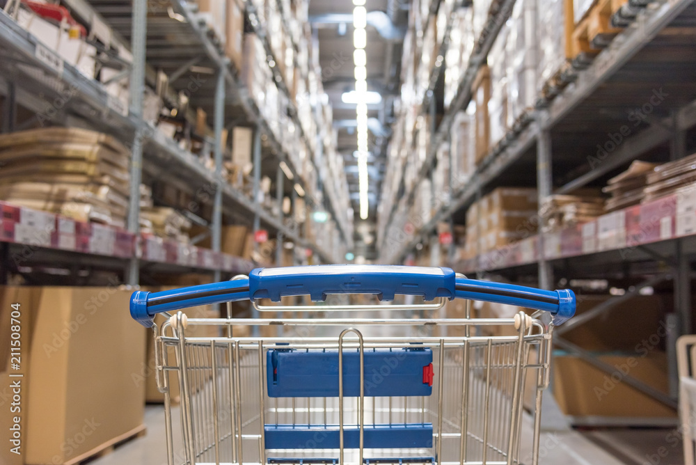 Warehouse storage of retail merchandise shop. Trolley Shopping Cart ...