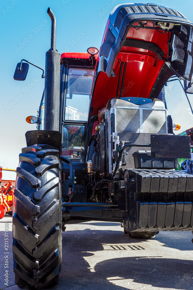 Tractor for farm work, modern agricultural transport working in the ...