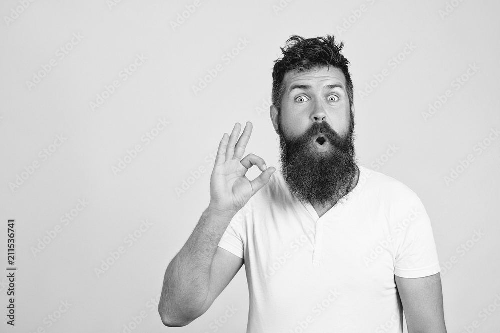 young funny man okay. Stupefied emotive male keeps hand in okay gesture ...