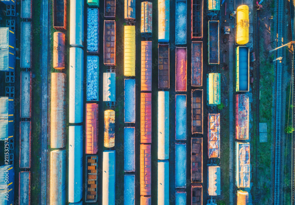 Aerial view of cargo trains. Railway wagons with goods on railroad. Top ...