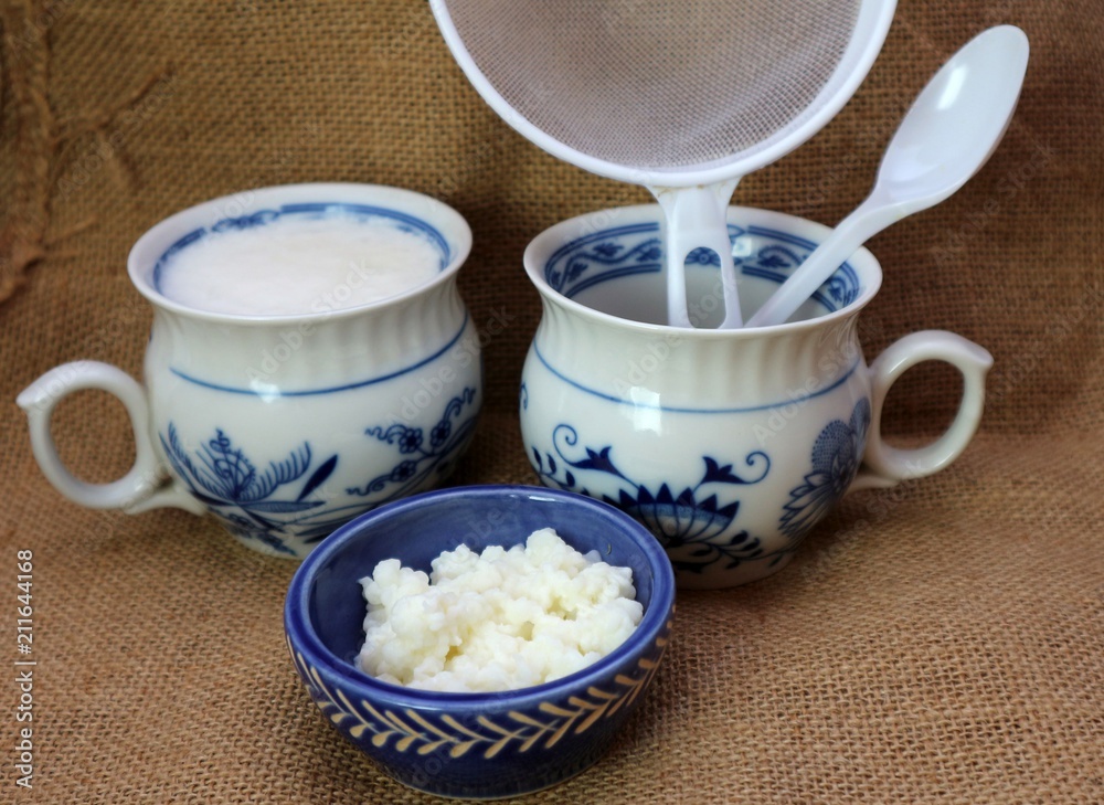 Milk kefir grain and fresh homemade kefir fermented milk with plastic ...