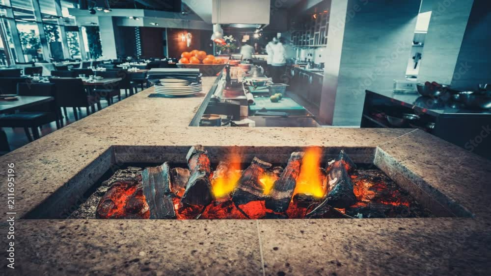 Open kitchen in modern restaurant interior. Bar counter made of natural ...