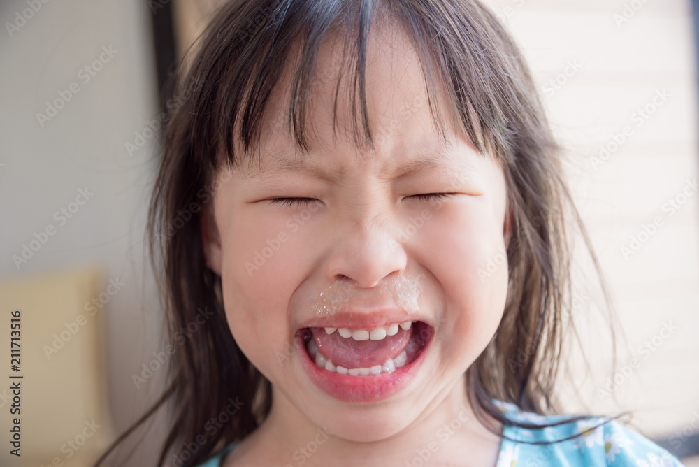 Little asian girl crying with running nose Stock Photo | Adobe Stock