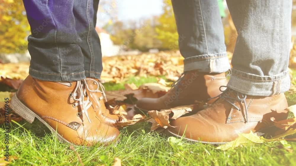A footage of a couple's boots while a woman kisses her boyfriend Stock ...