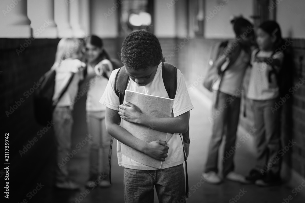 Sad pupil being bullied by classmates at corridor Stock Photo | Adobe Stock