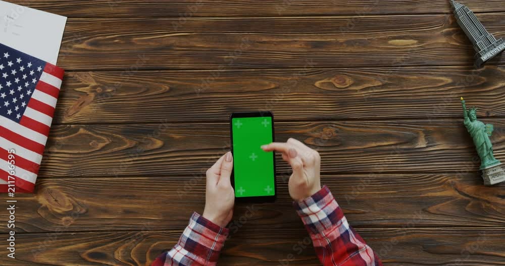 View from the top on the woman's hands scrolling and taping on the ...