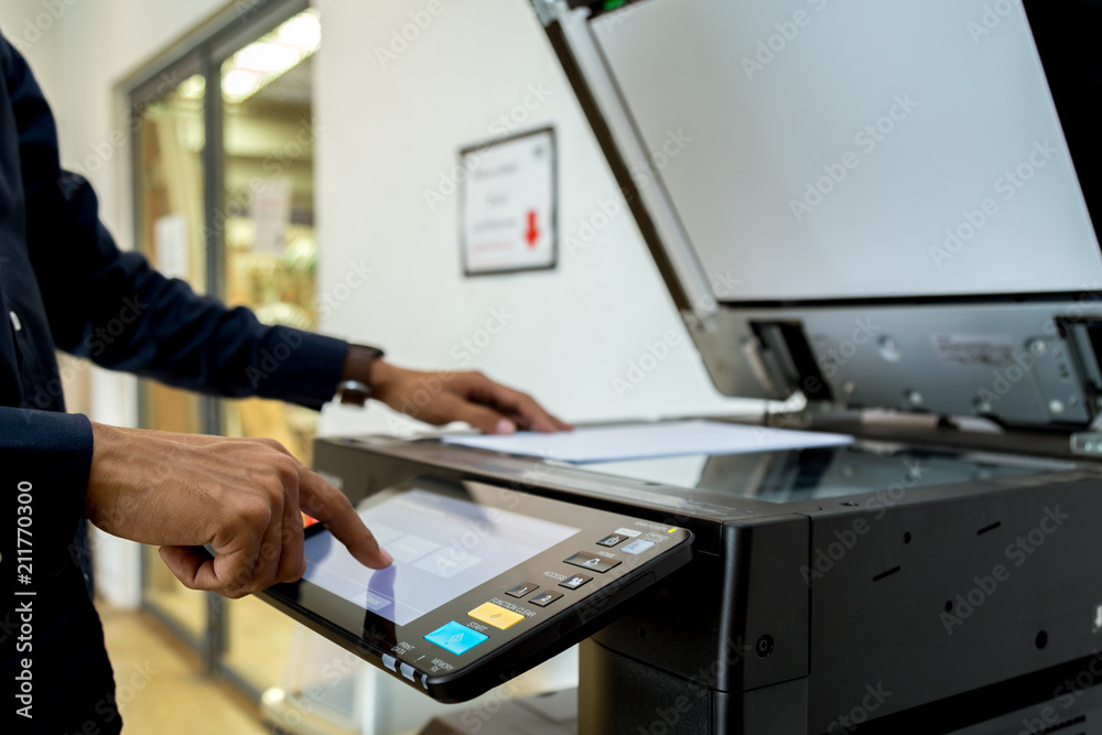 Bussiness man Hand press button on panel of printer, printer scanner ...