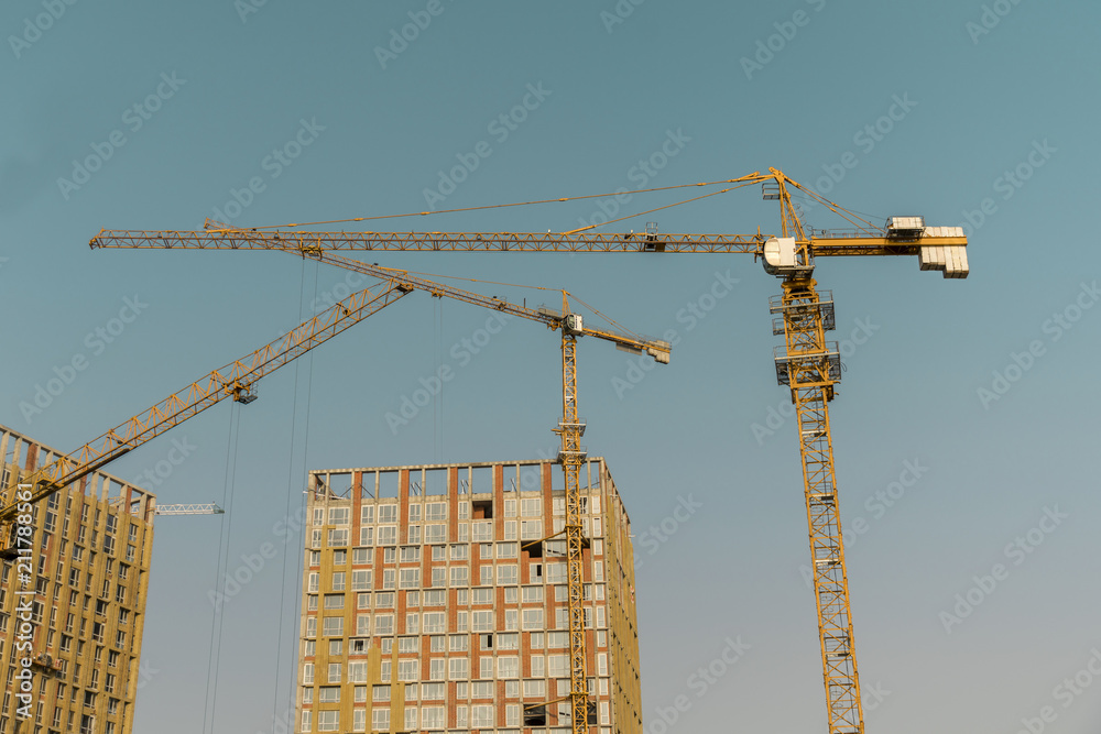 Hoisting crane and new multi-storey building. ndustrial background ...