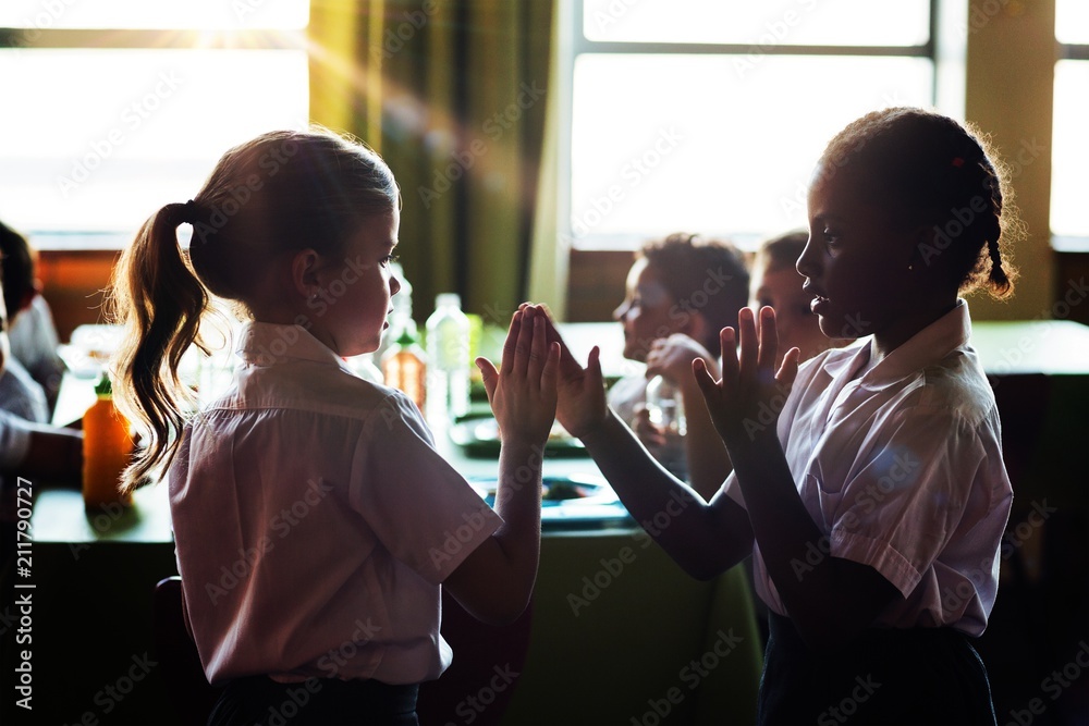 Girls playing clapping game Stock Photo | Adobe Stock