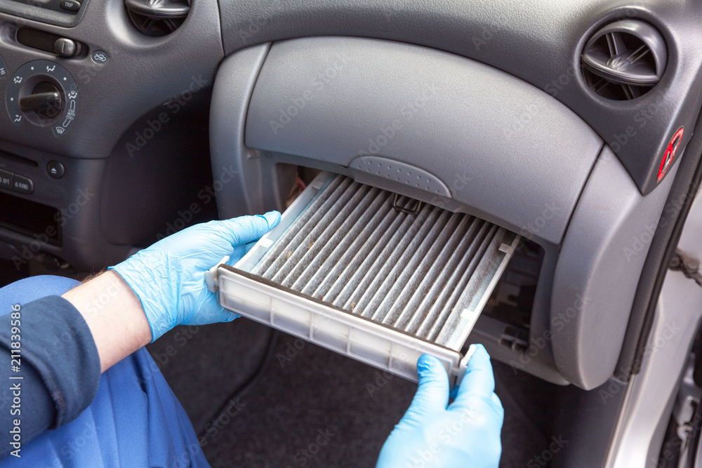 Replacing an old car cabin air filter Stock Photo | Adobe Stock