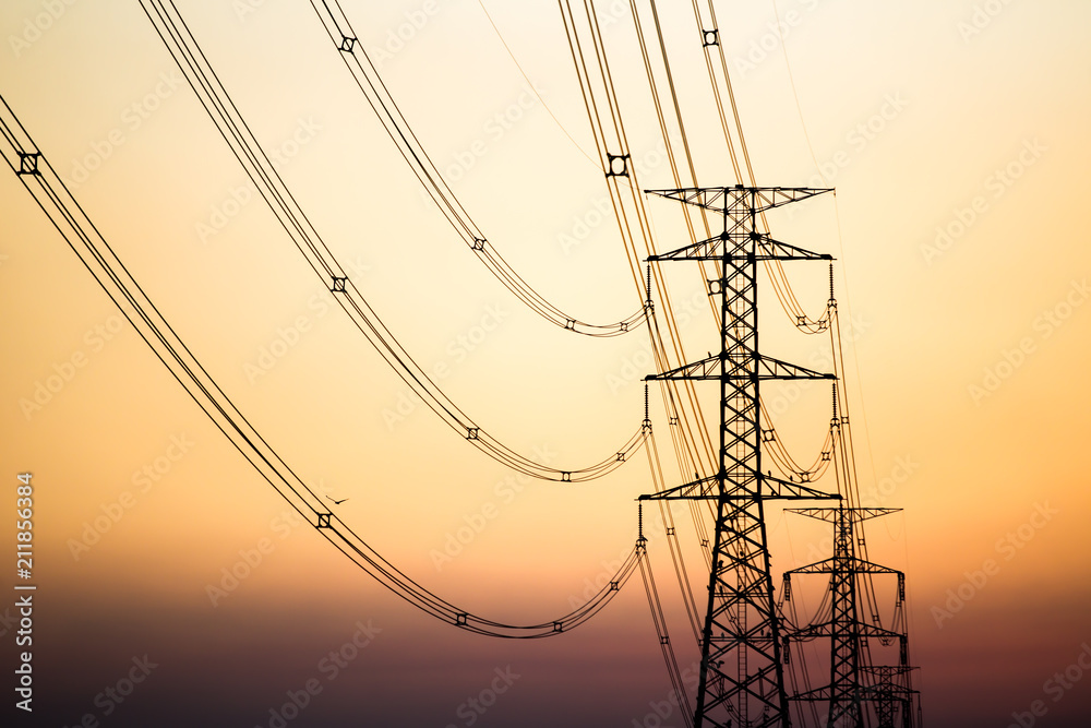 High voltage power tower close up on the worm tone sky before sunset ...