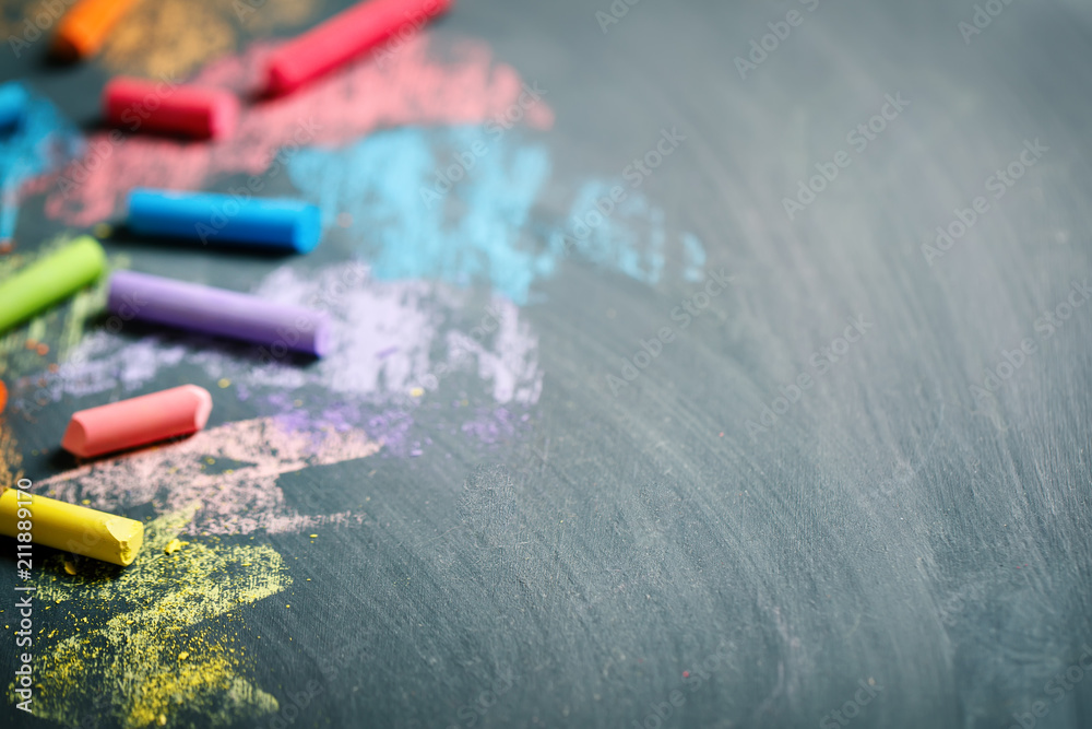 Colorful crayons on the blackboard, drawing. Back to school background ...