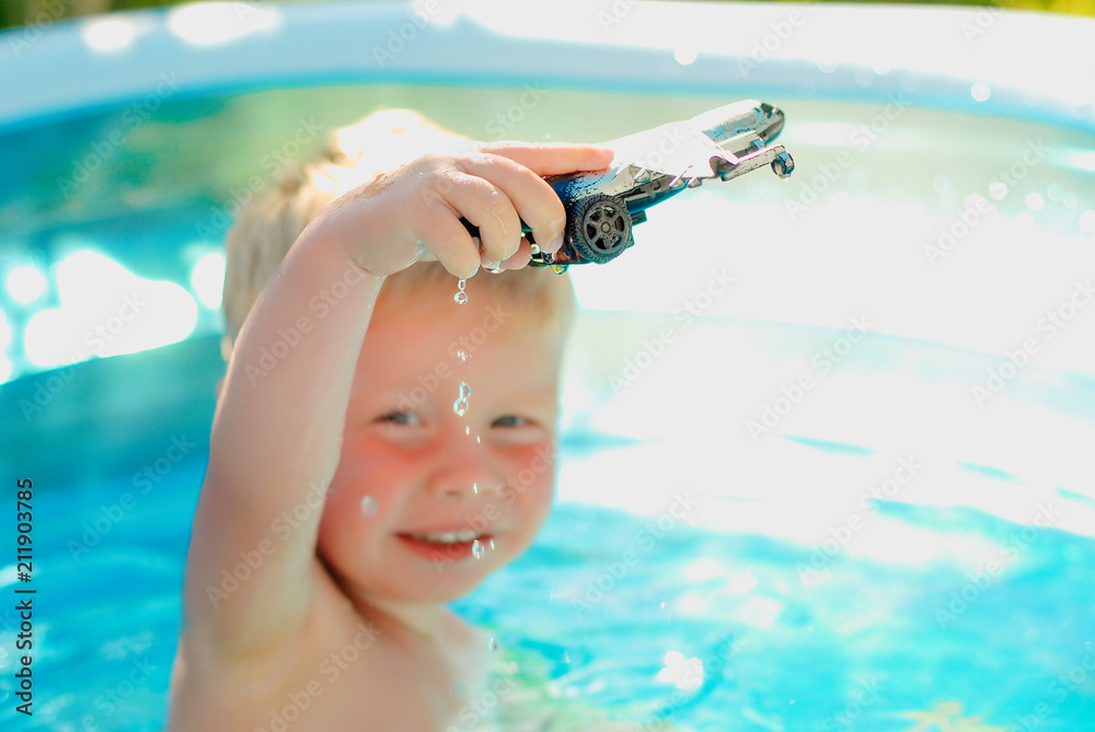 Baby with toy plane in swimming pool. Little boy learning to swim in ...