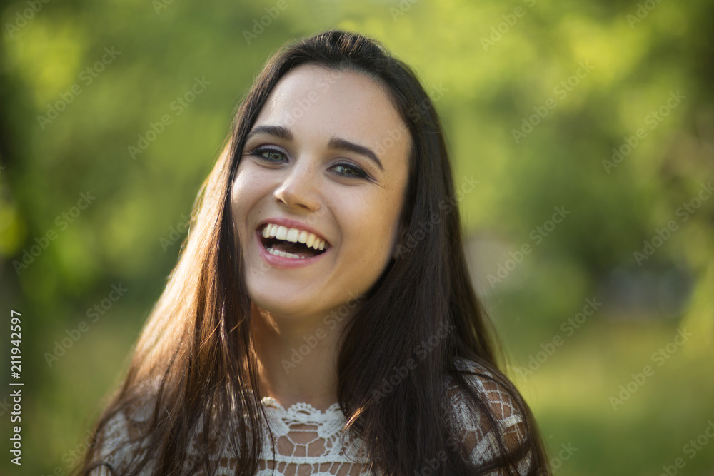 Portrait of gorgeous woman laughing genuinely. Pretty girl with long ...