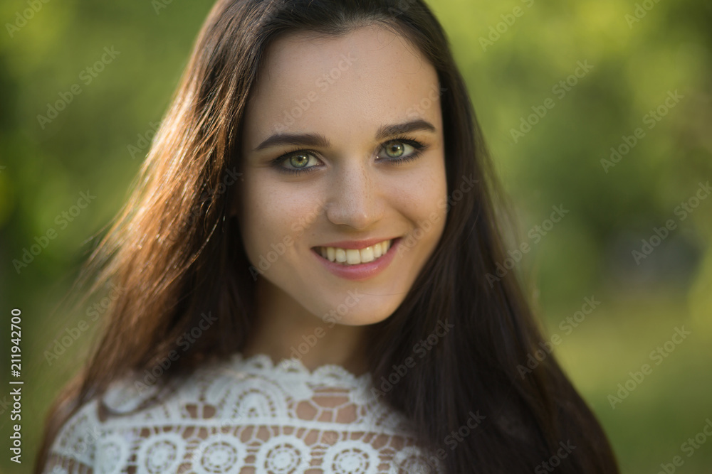 Gorgeous woman smiling softly. Lovely looking girl with bright green ...