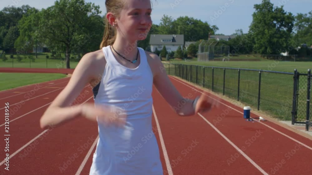 Teen girl athlete exercising on a running track Stock Video | Adobe Stock