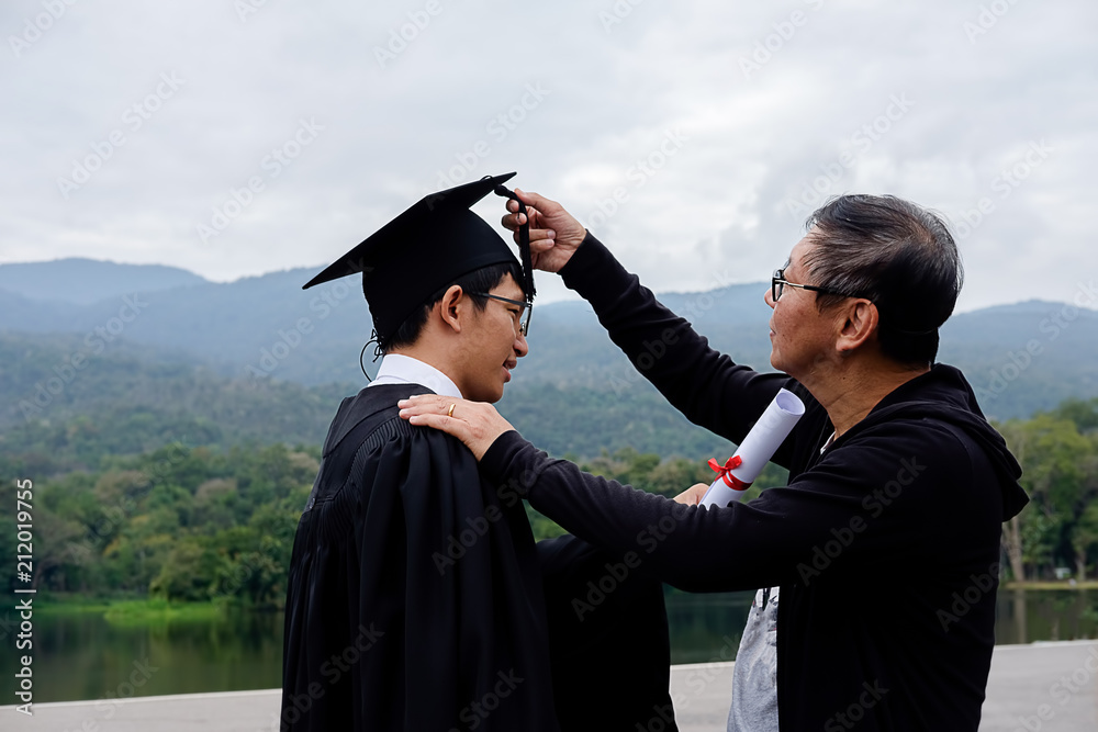 happy man on her graduation day University. student in graduation cap ...