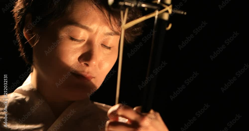 Korean female musician playing the Haegeum which is the Korean ...