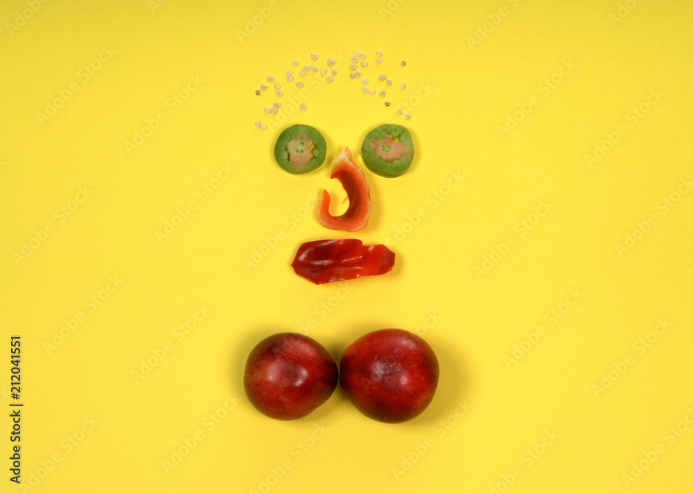 sad face made with various raw vegetables, a smiley face on a yellow ...