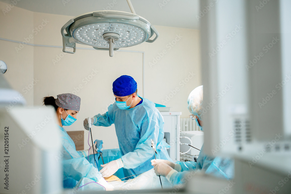 Real process laparoscopy operation. Surgeons team preforming operation ...