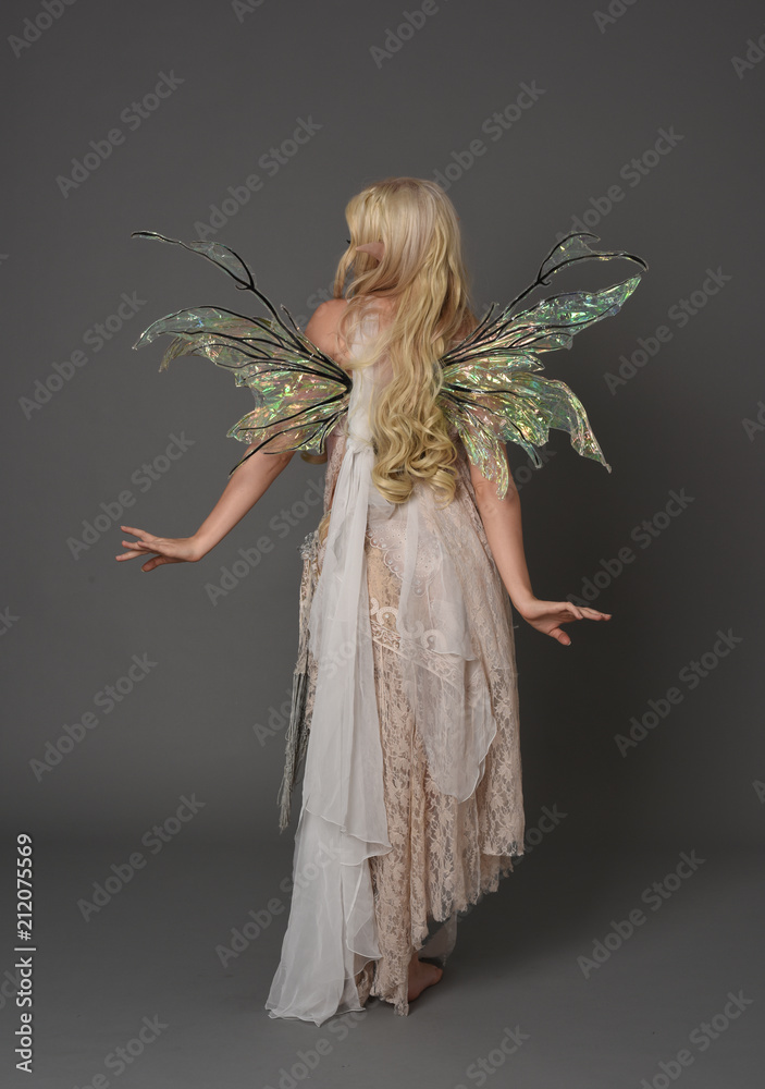full length portrait blonde girl waring fairy costume, standing pose ...