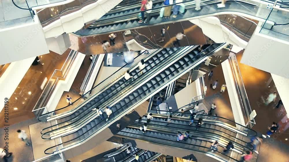 People on many fast moving Escalators In big modern shopping mall ...