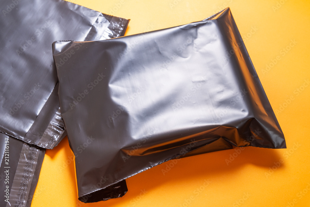 Black polythene envelope on office desk. Stock Photo | Adobe Stock