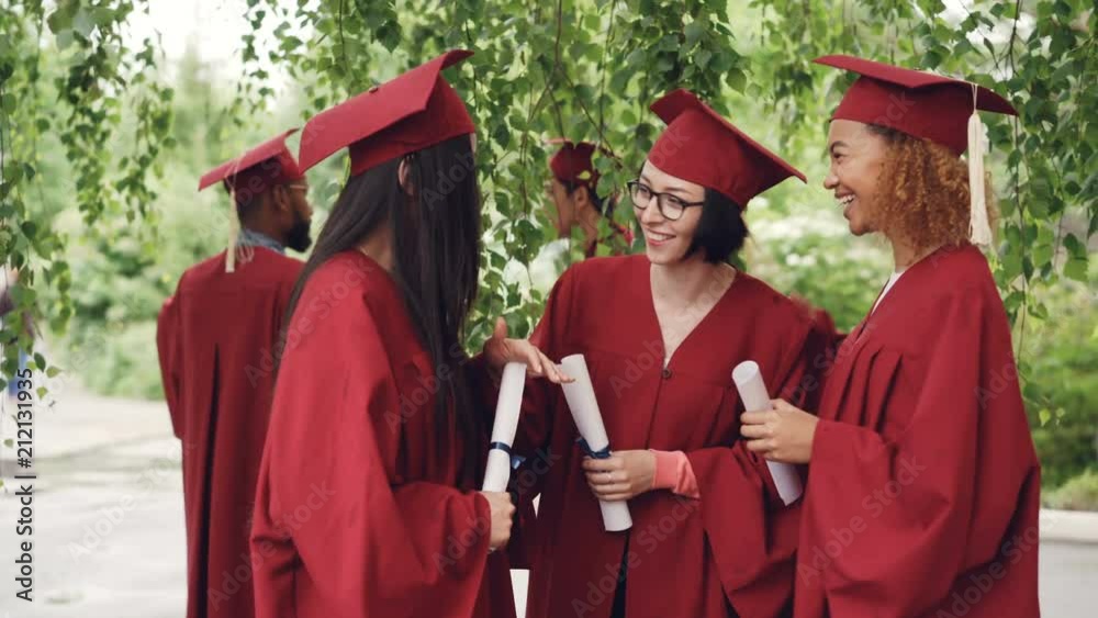 Fellow students are talking and laughing after graduation ceremony ...