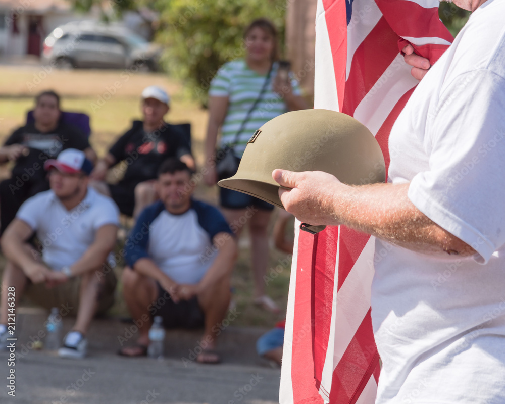 Side view a white veteran proudly holding military WWI helmet (M1 ...
