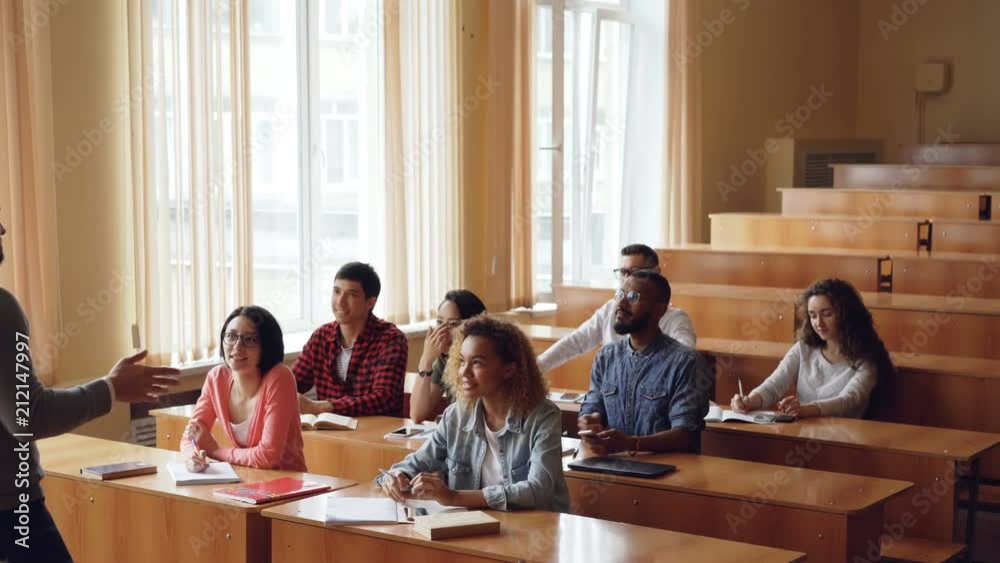 Young people college students are laughing and talking to friendly ...