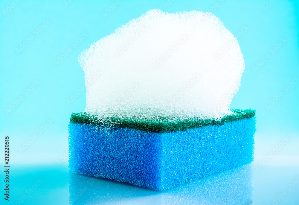 Sponge with foam and bubbles, close-up, texture, light blue background ...