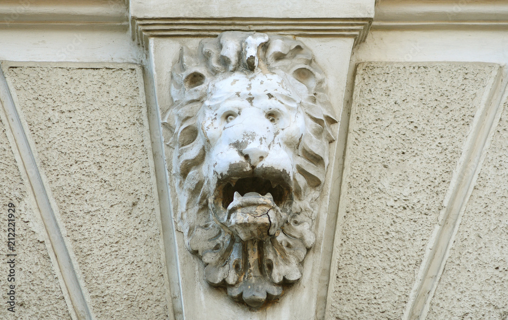 Stone lion head on a building facade. Detail of an ancient architecture ...