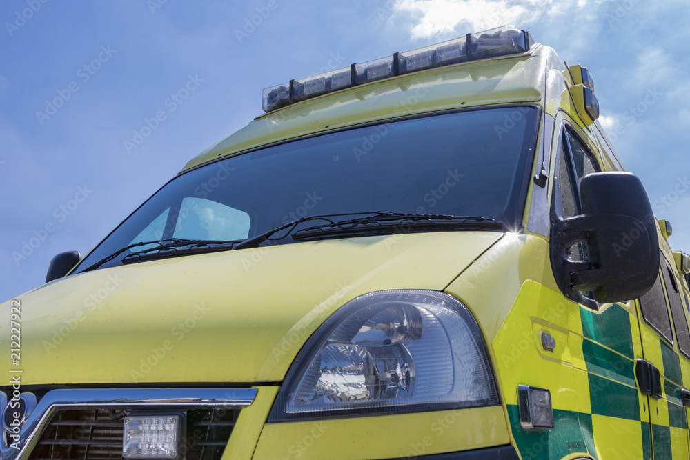 Yellow and green British Ambulance on a sunny day Stock Photo | Adobe Stock