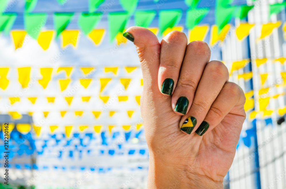 Hand closed, showing nails painted with the colors of the flag of ...