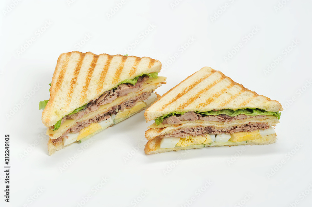 Two sandwiches of triangular shape made of white bread. The filling of ...