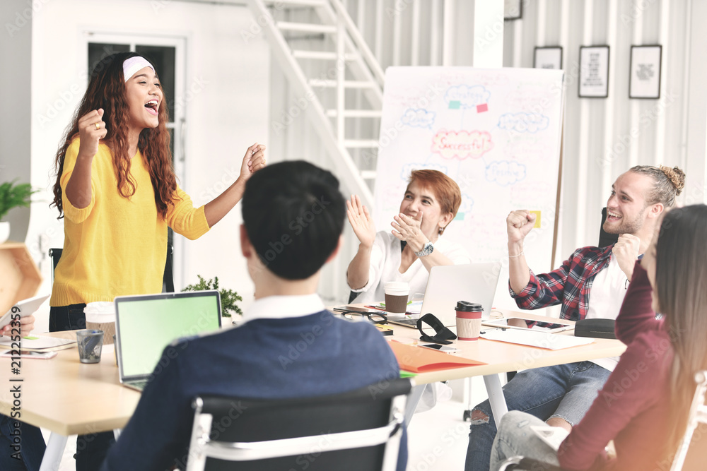 Young businesswoman giving motivational and team building speech to ...