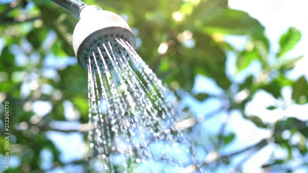 Outdoor beach shower with fresh water in slow motion on beautiful blue ...
