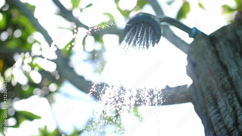 Outdoor beach shower with fresh water on beautiful blue sky background ...