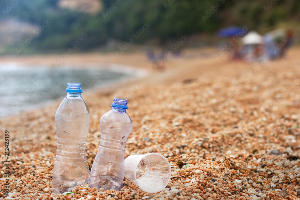 Plastic bottles on a beach, pollution of seas with plastic waste ...