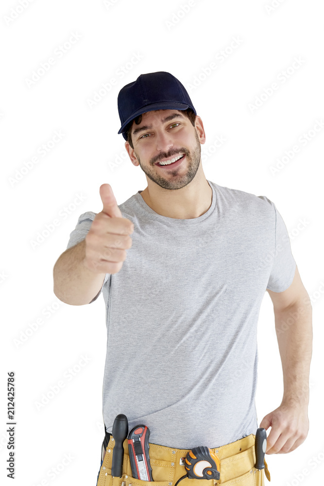 Thumbs up. Young construction worker with tool belt standing at ...