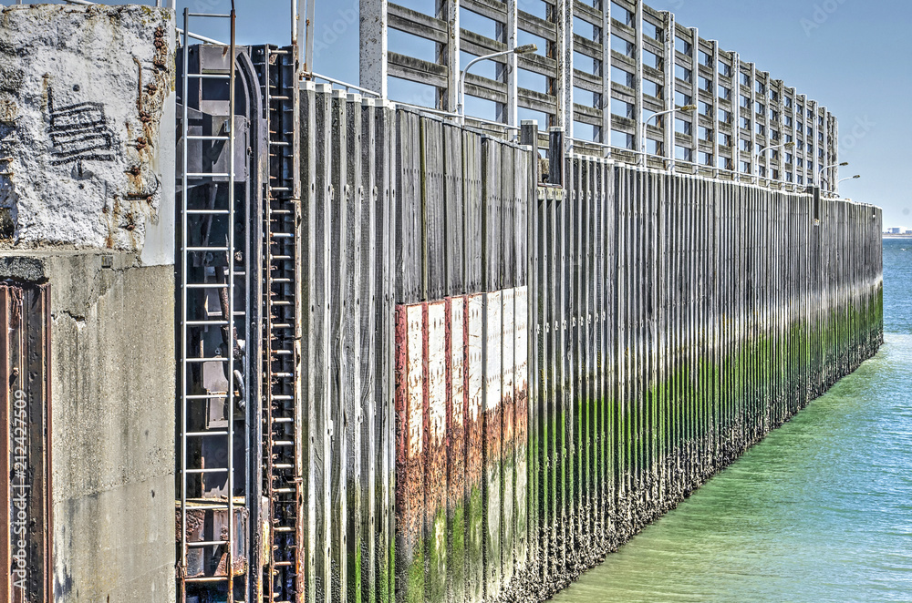 Elements of concrete, steel and wood in the quay wall of the feery ...