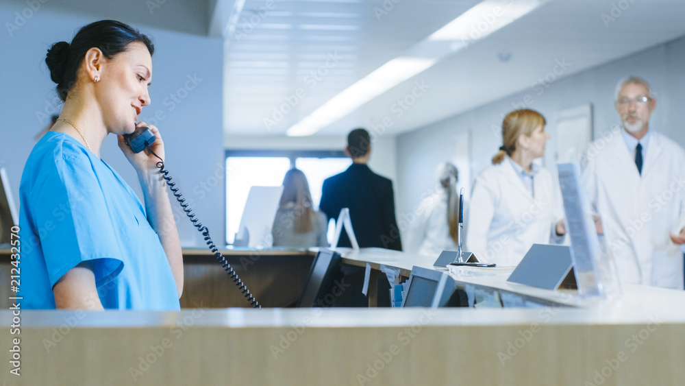 In the Hospital at the Reception Desk Nurse on Duty Talking on Phone ...