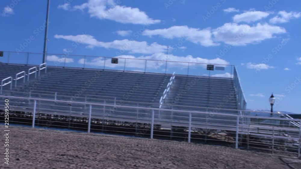 Pan from right to left starting at the roping gate of an empty rodeo ...