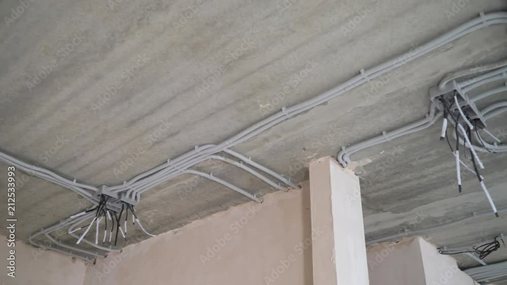 Electrical installation of plastic tubes on building site. Fix boxes ...