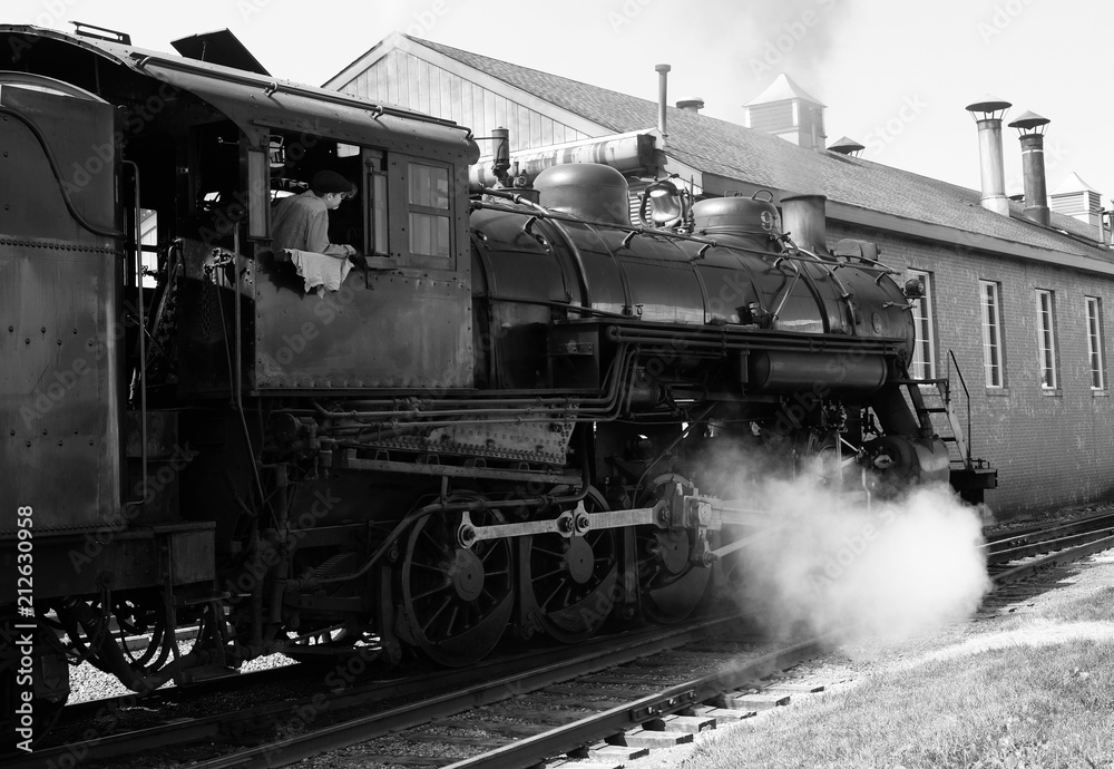 Steam train in rail yard blowing steam Stock Photo | Adobe Stock