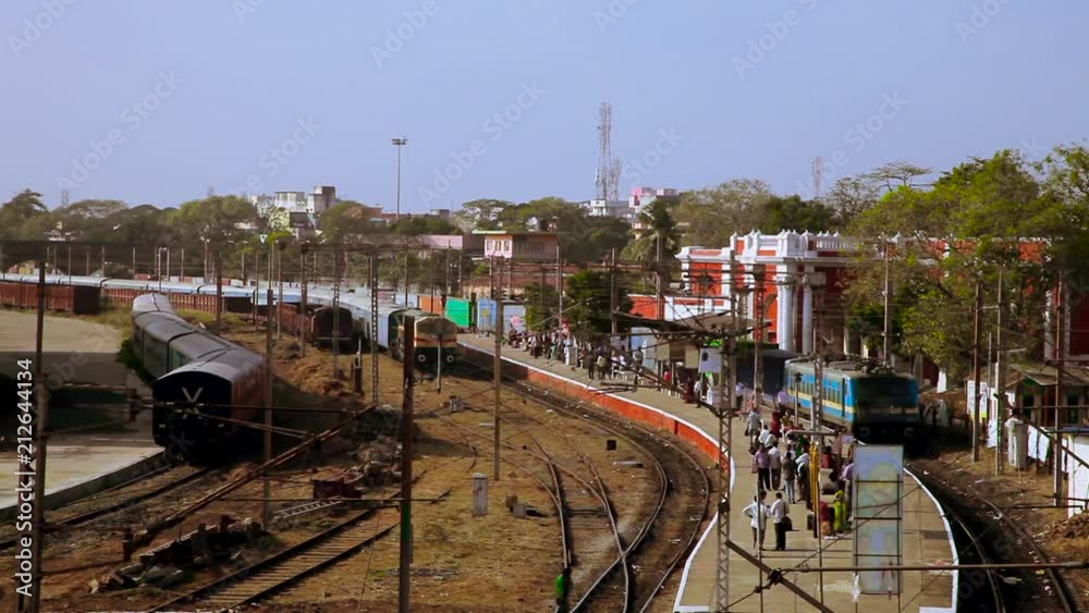 Train arriving at the train station, People waiting for their trains in ...