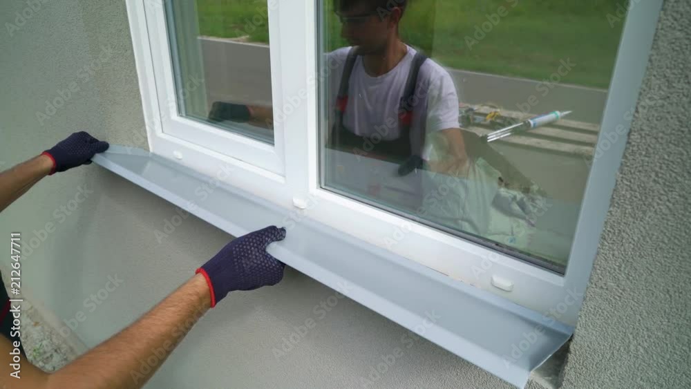 Man worker in safety glasses and protective gloves installing metal ...